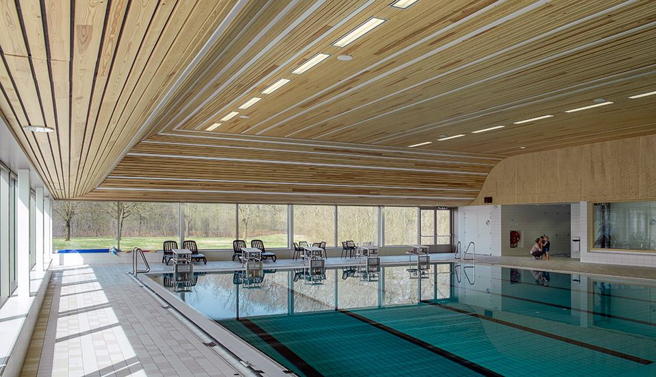 Swimming pool with inspiring solid wood ceiling | Derako | Archello