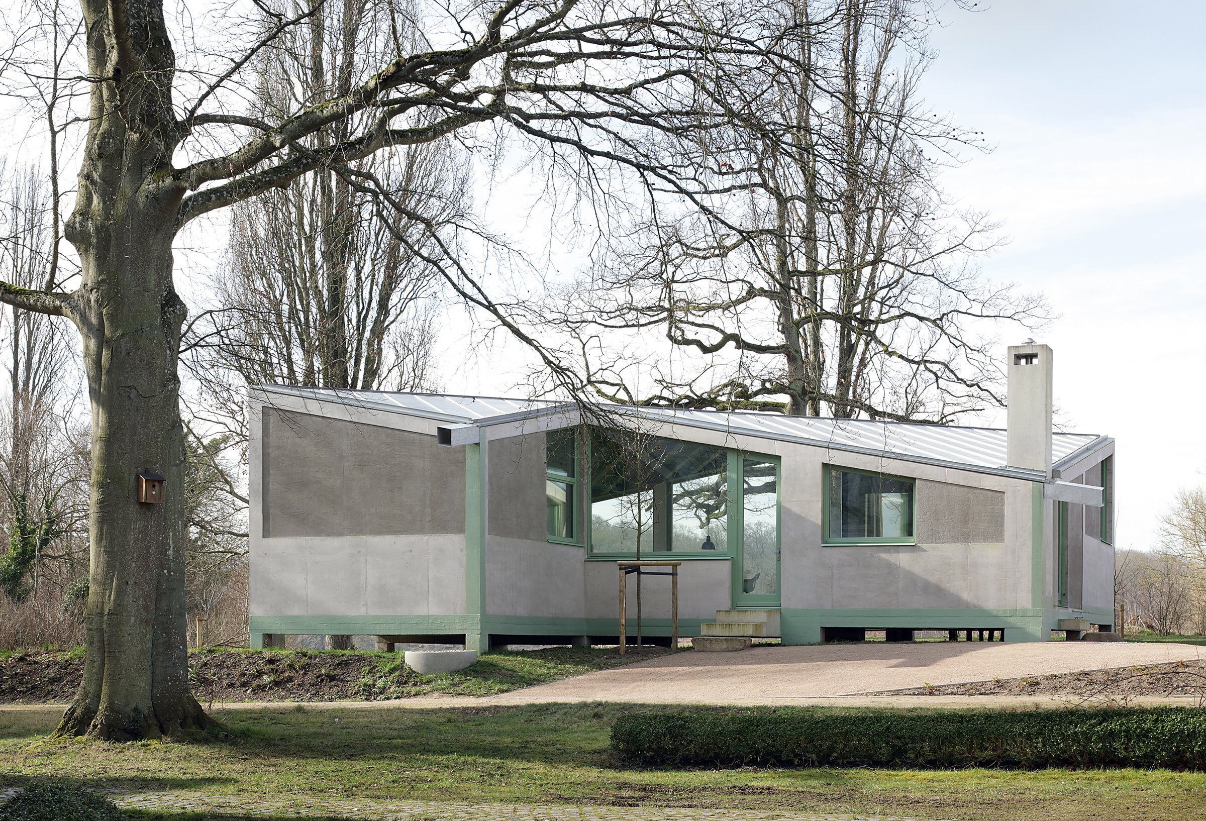 Z-shaped lakefront retreat features a dynamic diagonal ridgeline and a ...