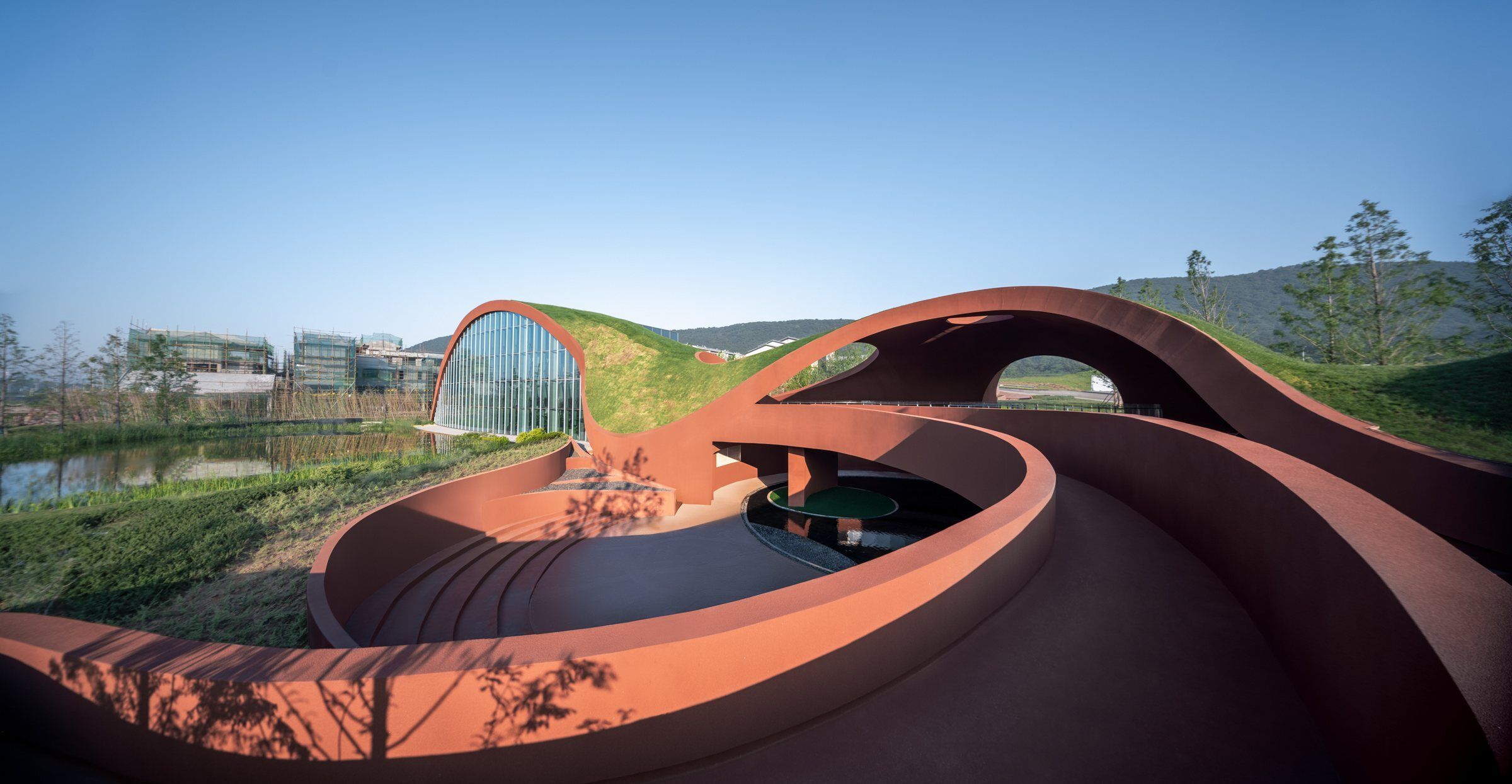 Organic forms and flowing landscape wrap this cultural centre in China ...